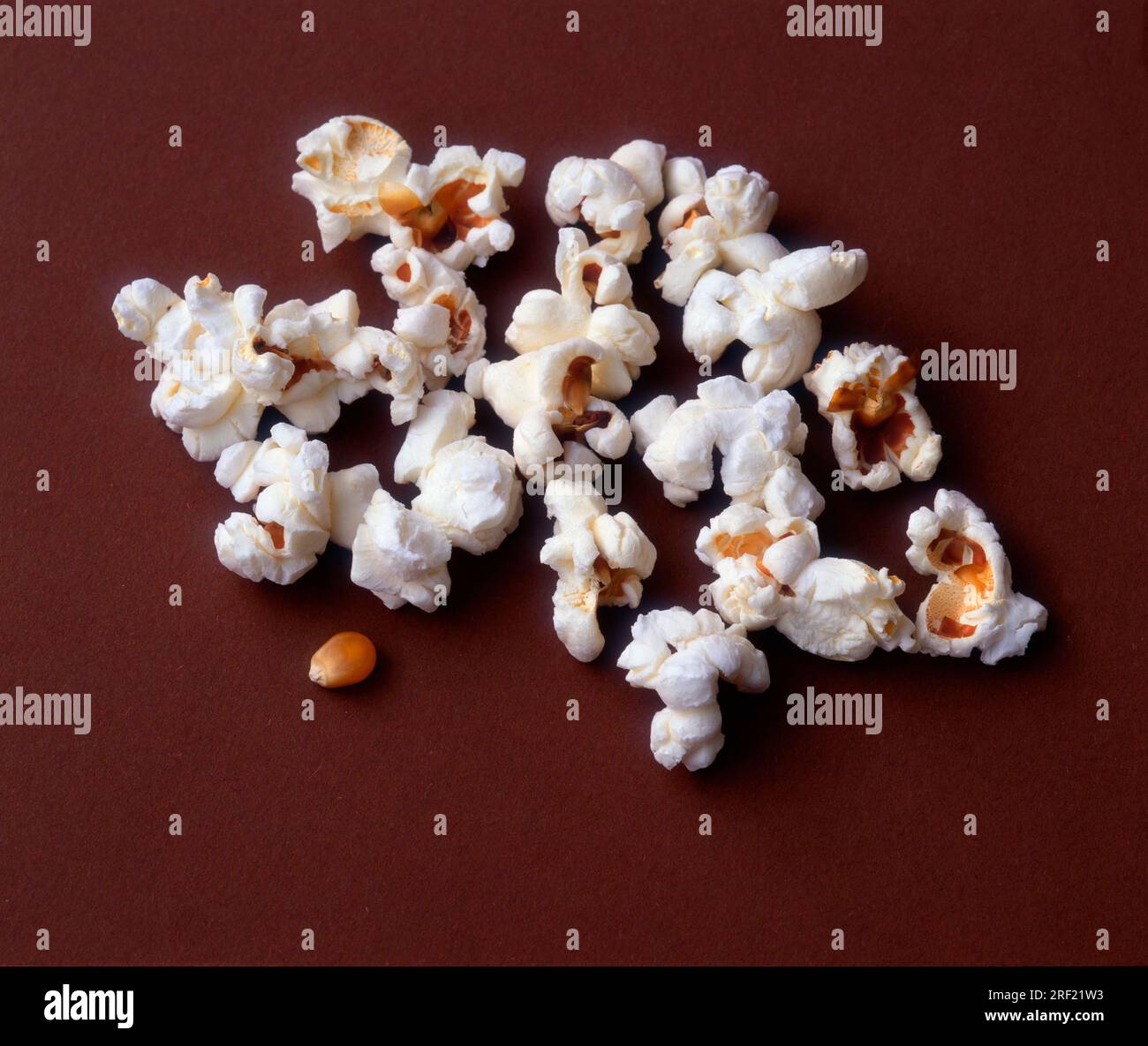Popcorn spilling out of a bowl Stock Photo - Alamy