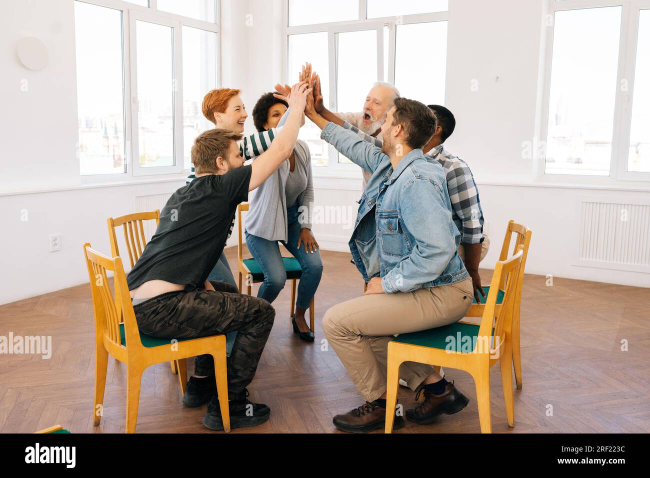 Diverse happy multicultural and different ages people reach hands to ...