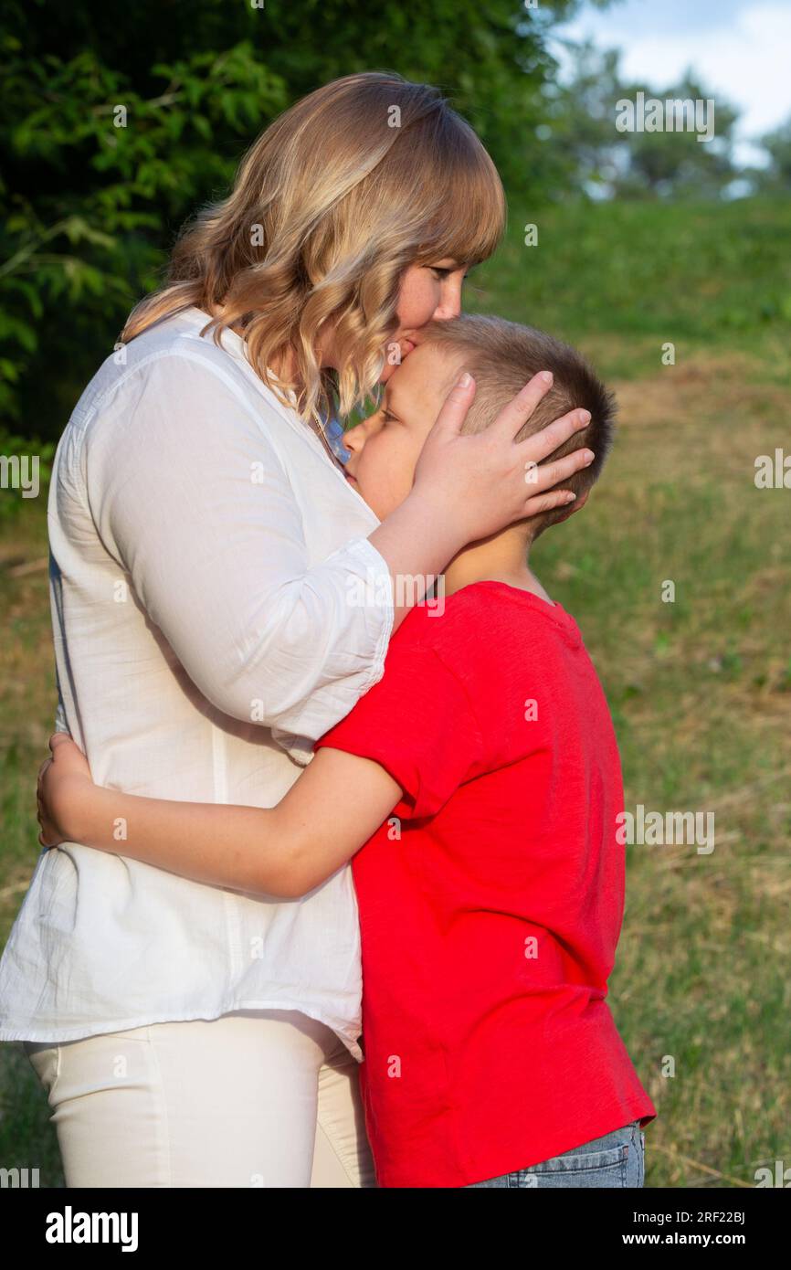 Happy mom and son hugging on a summer walk Stock Photo - Alamy