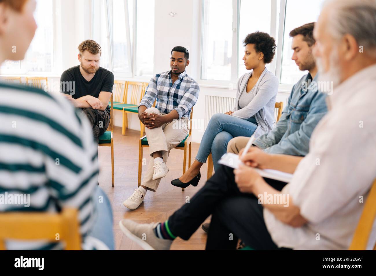 Back view to depressed black male drinker talking about alcohol ...