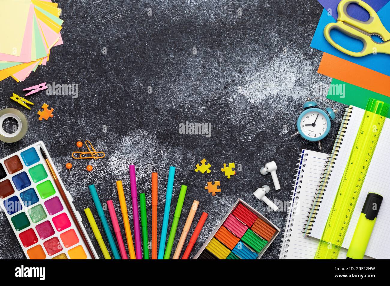 School supplies on a chalkboard background. Office stationery on ...