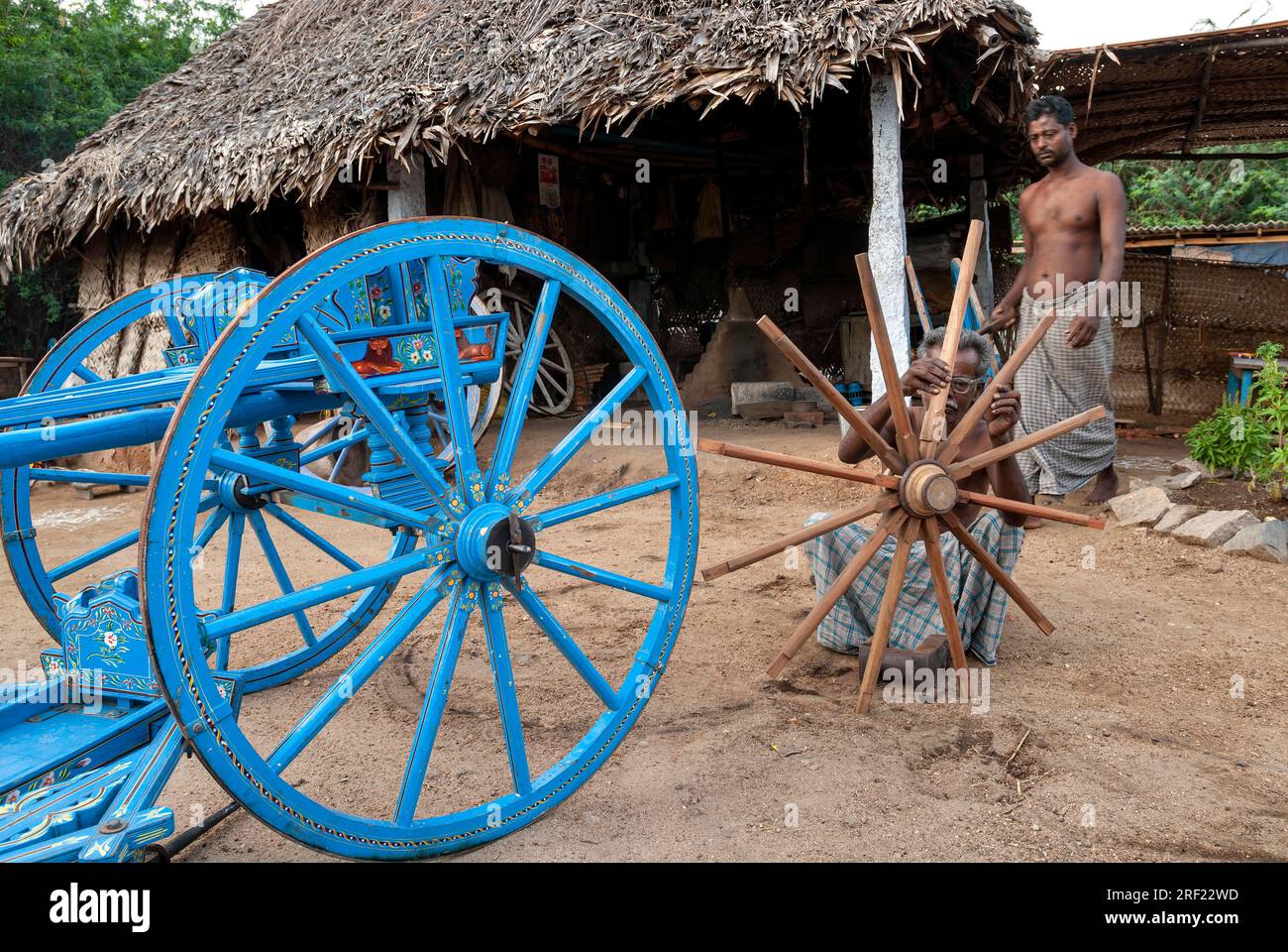 A carpenter assembling wooden cart wheel near Madurai, Tamil Nadu ...