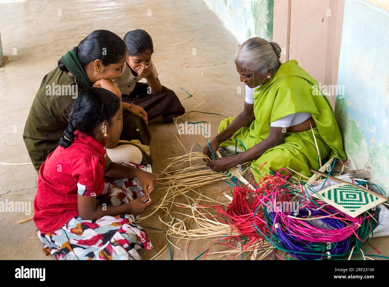 An old lady in the process of making palm leaf products at Manapad near ...