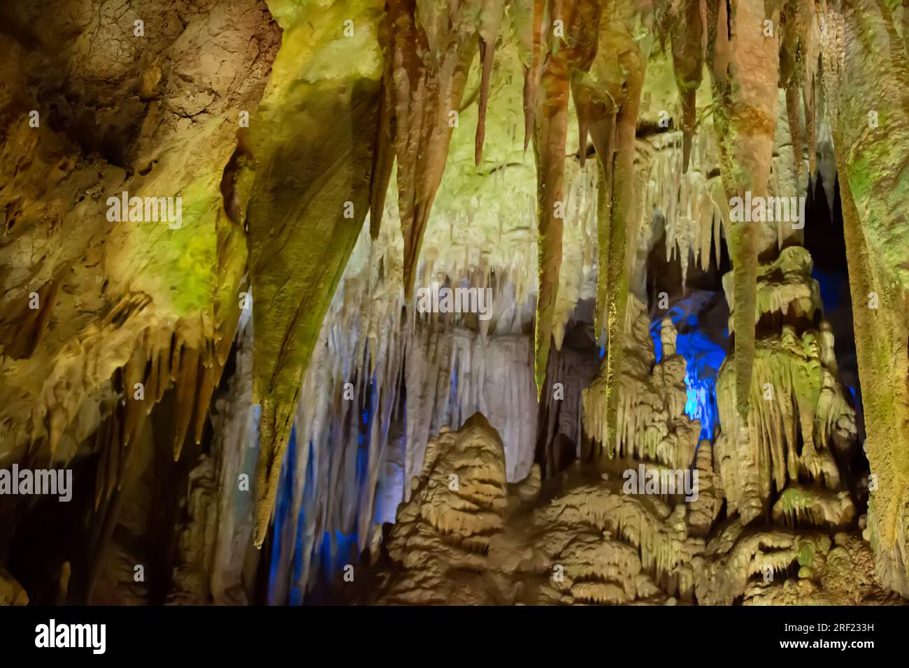 Karst cave, amazing view of stalactites and stalagnites in colorful ...