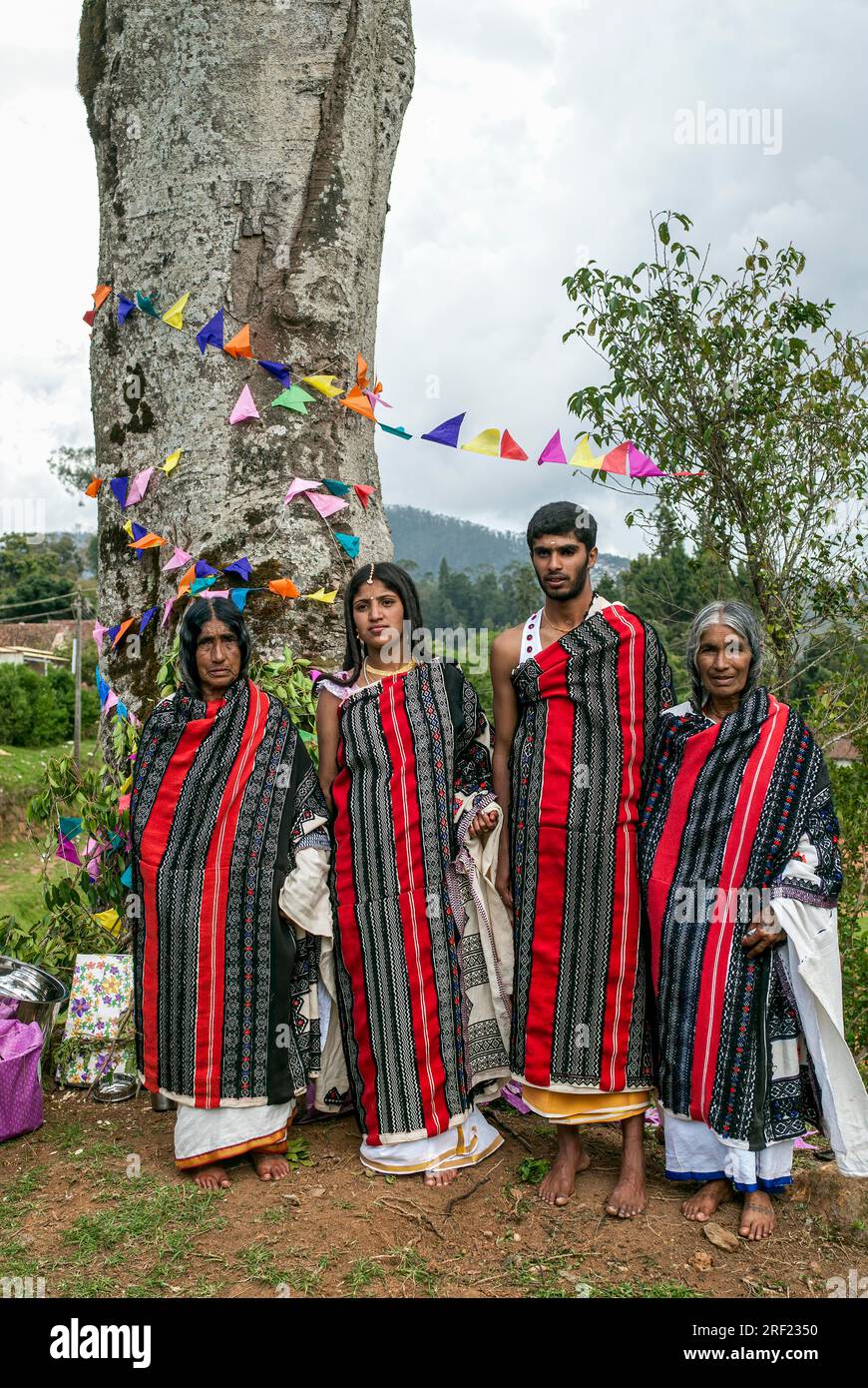 Toda Bride and Groom standing with relatives under the sacred tree ...