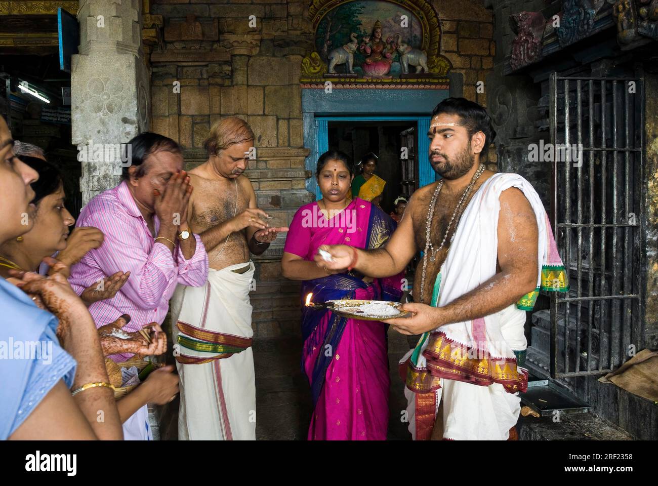 Priest offering Vibuthi Vibhuti sacred white ash to devotees in ...