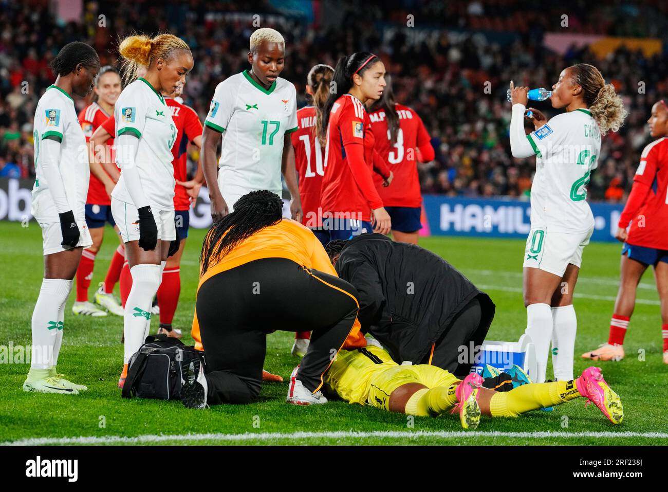 Zambia's goalkeeper Catherine Musonda lies on the ground as she ...