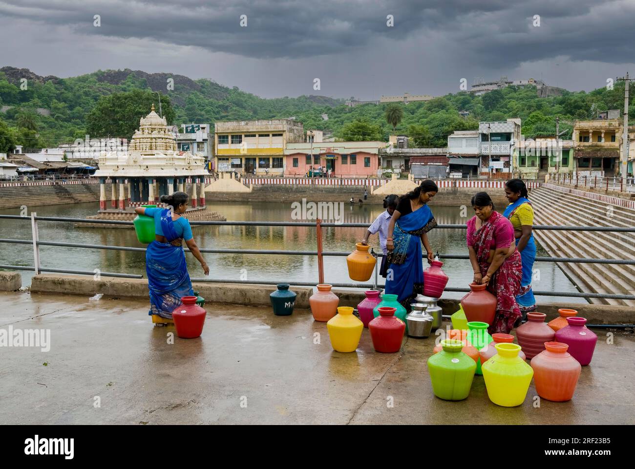 Women collecting drinking water from municipal tap near Saravana Poigai ...