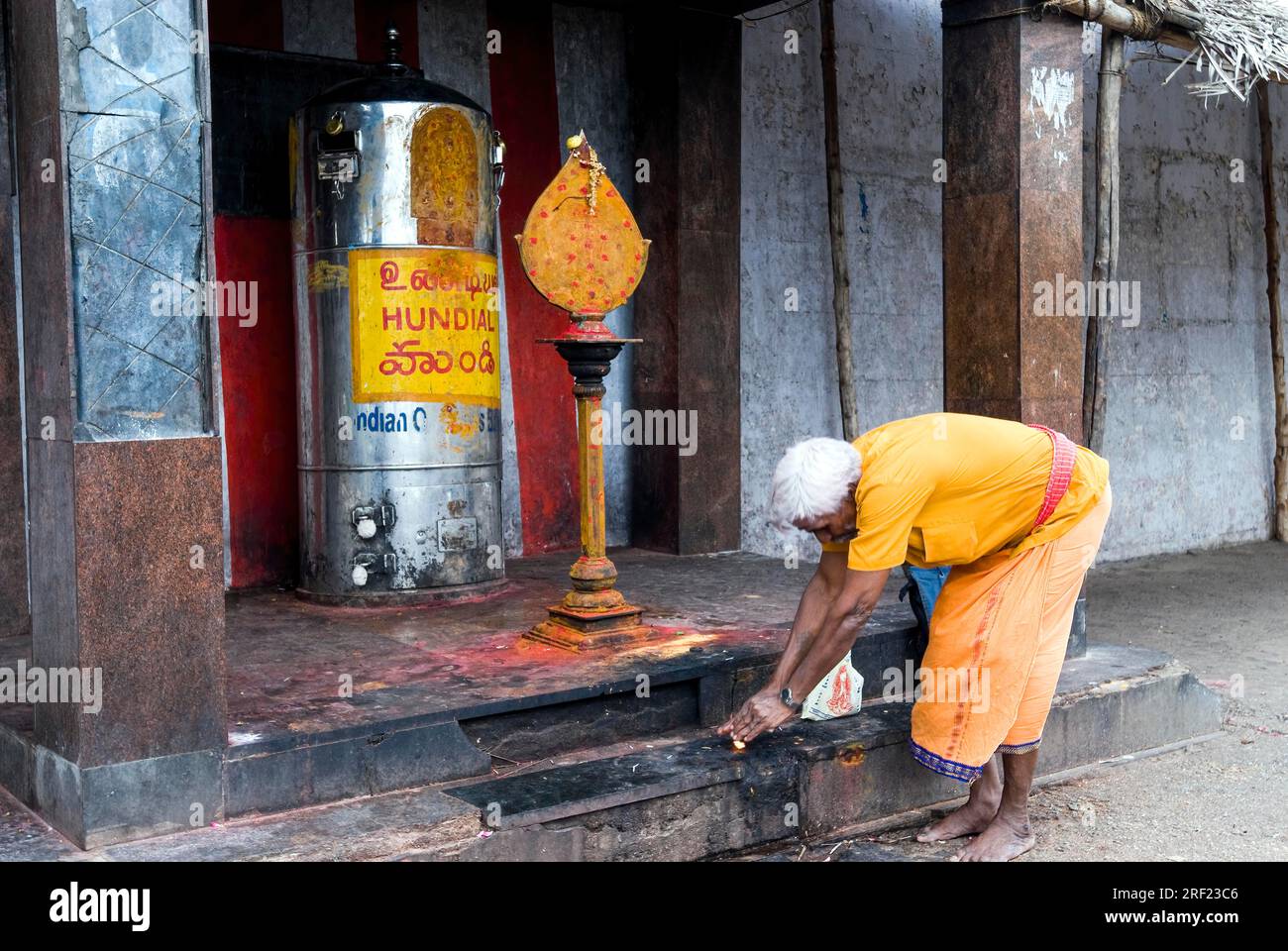 A devotee worshipping Vel Spear at hilltop in Lord Murugan Temple at ...