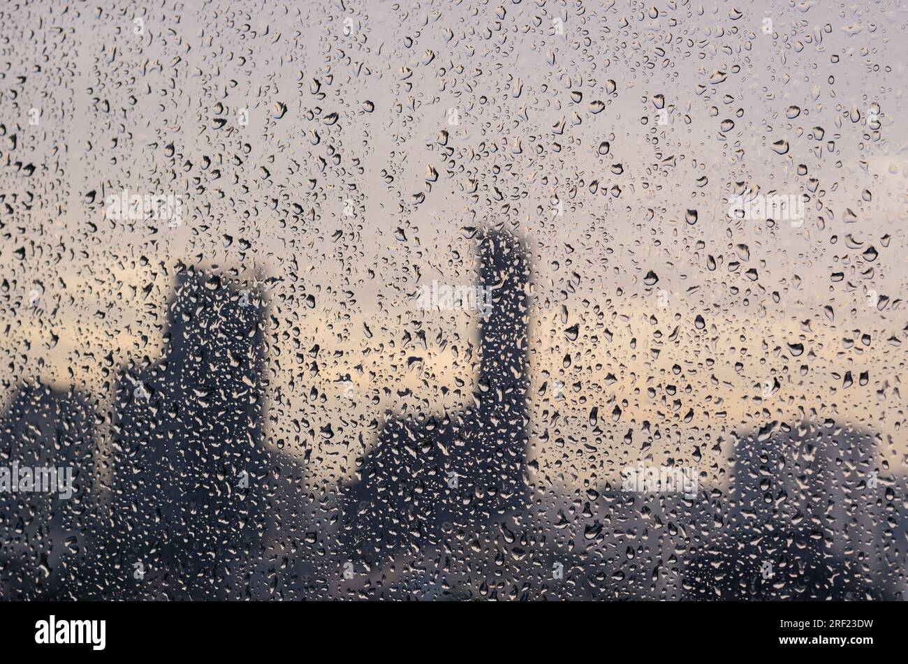 Rain drop on glass window in monsoon season when dusk time with blurred ...