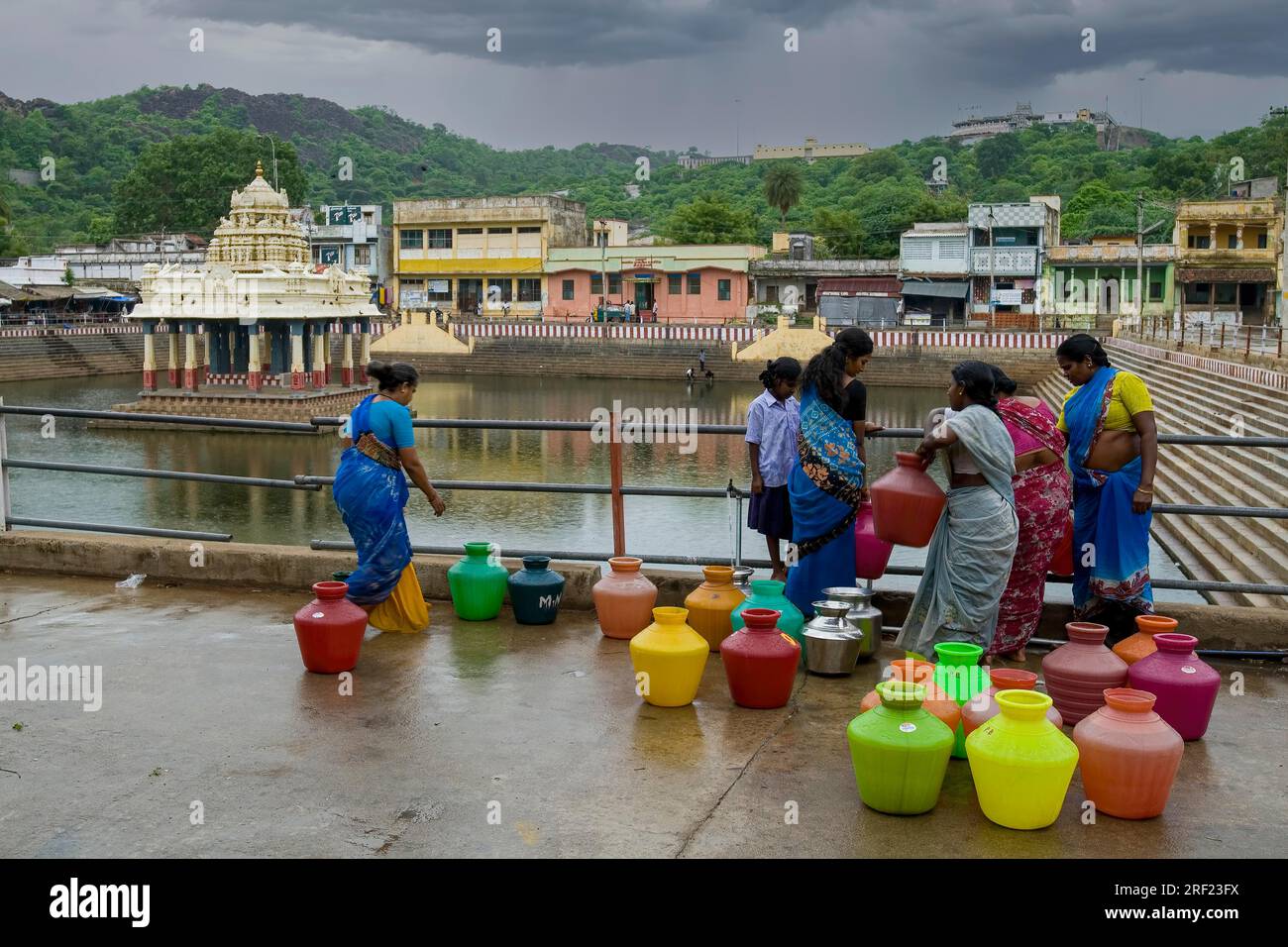 Women collecting drinking water from municipal tap near Saravana Poigai ...