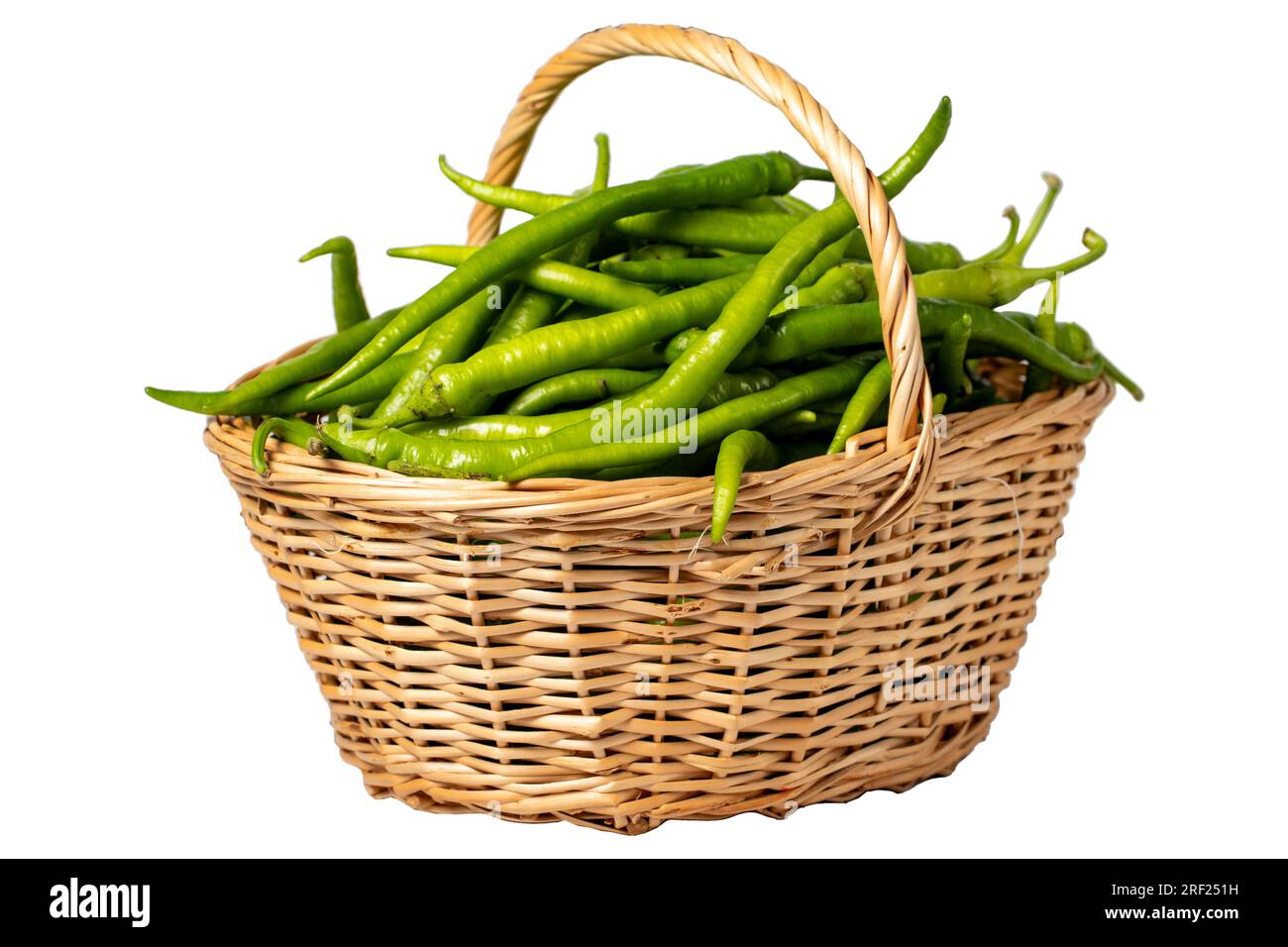 Fresh green pepper in a wicker basket isolated on white background ...