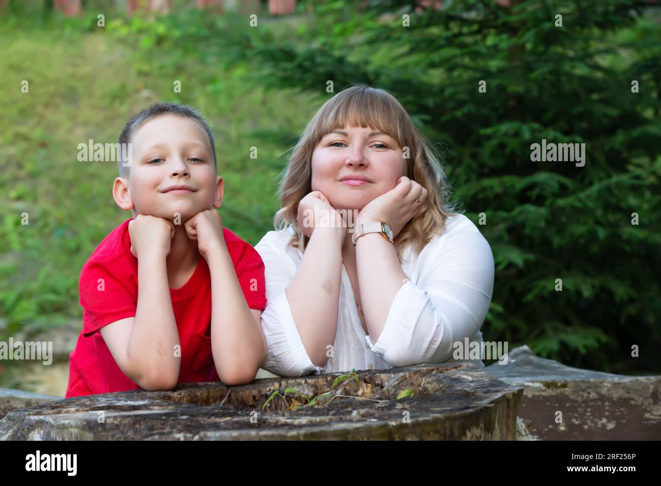 Happy mom and son are looking at the camera smiling Stock Photo - Alamy