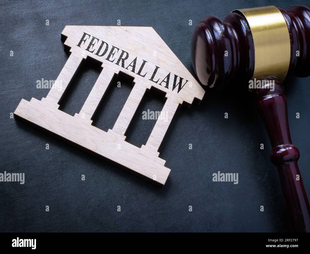 Wooden plate with Federal law words and gavel Stock Photo - Alamy