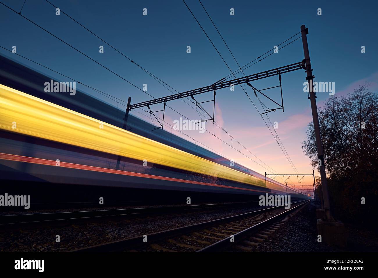 Railway at beautiful dawn. Long exposure of train on railroad track ...