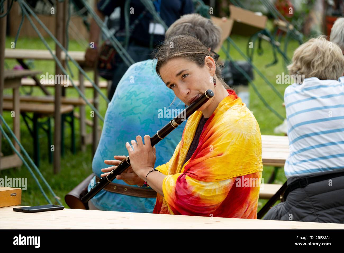 A woman playing a flute at Warwick Folk Festival, Warwickshire, UK ...