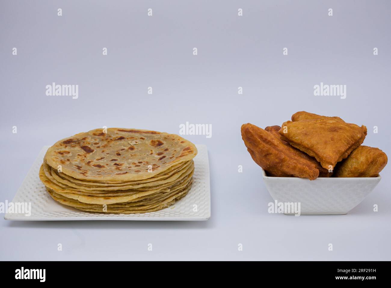 Chapati Mandazi Andazi Samosa triangular-shaped snacks on a plate on a ...