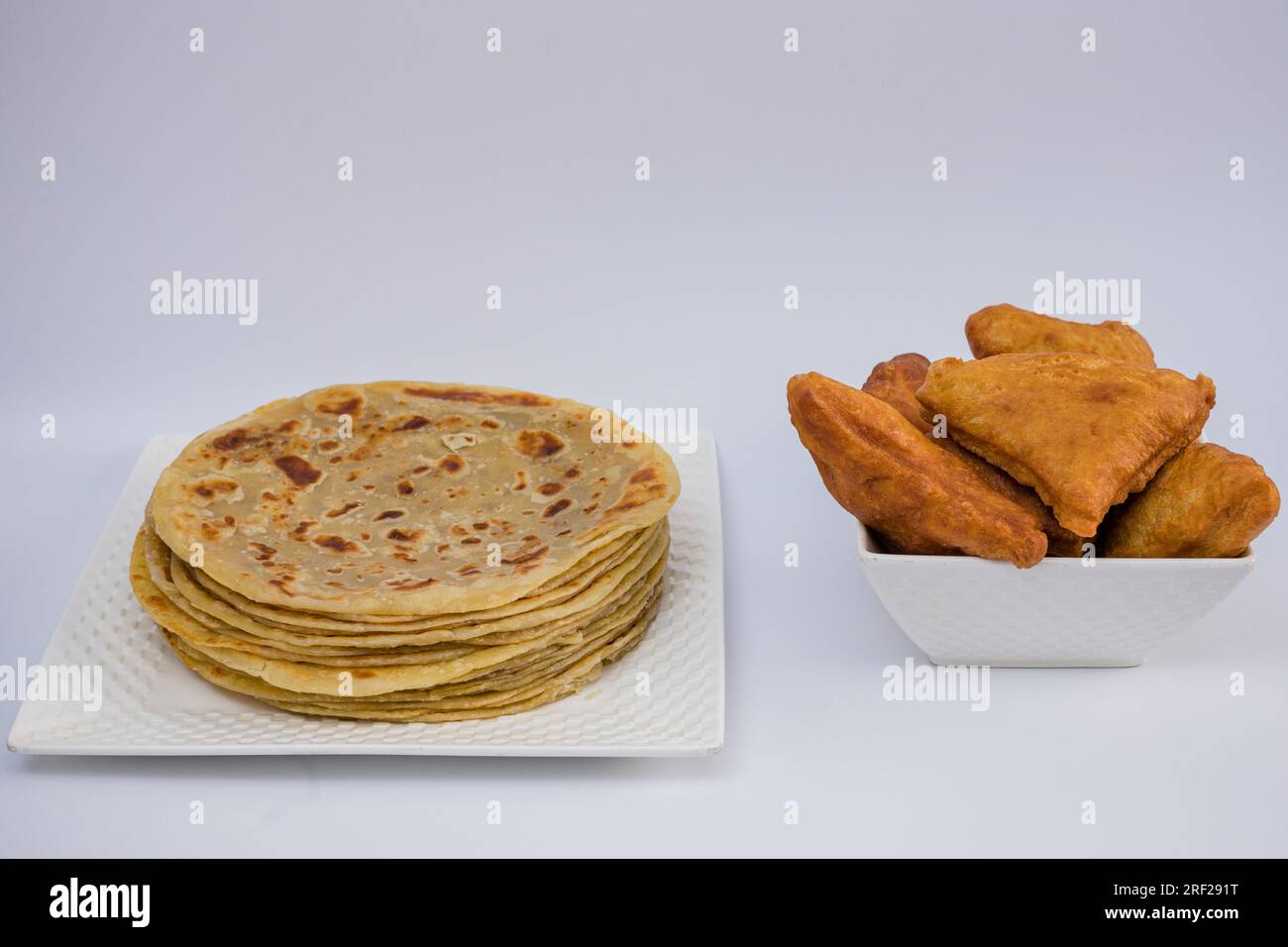 Chapati Mandazi Andazi Samosa triangular-shaped snacks on a plate on a ...