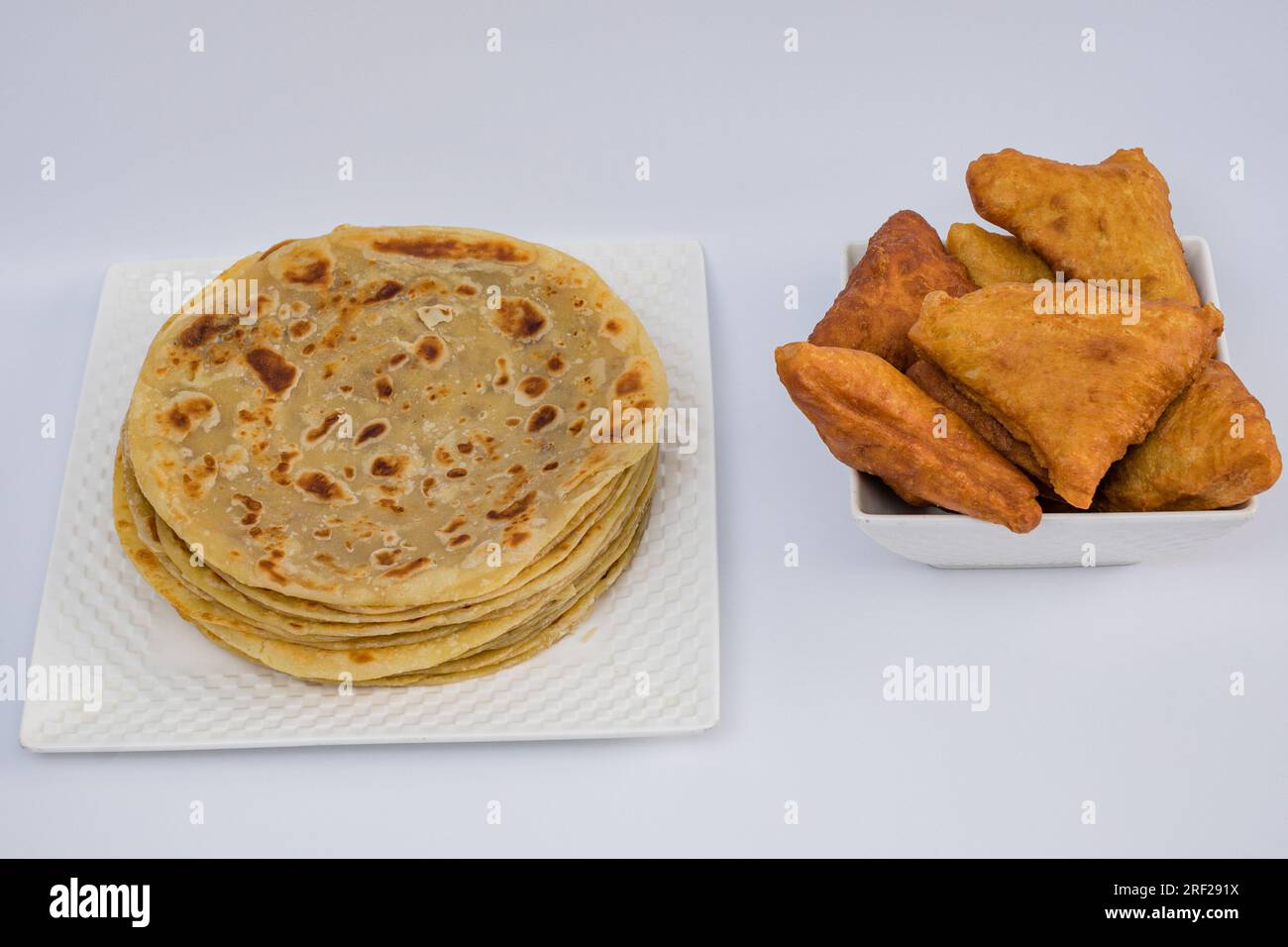 Chapati Mandazi Andazi Samosa triangular-shaped snacks on a plate on a ...