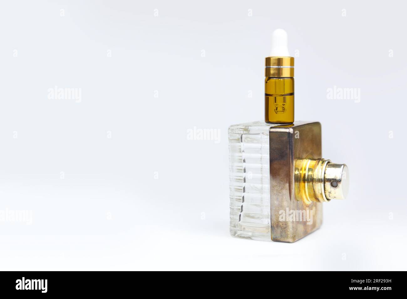 Serum in glass bottle with pipette and perfume spray bottle. Layout ...