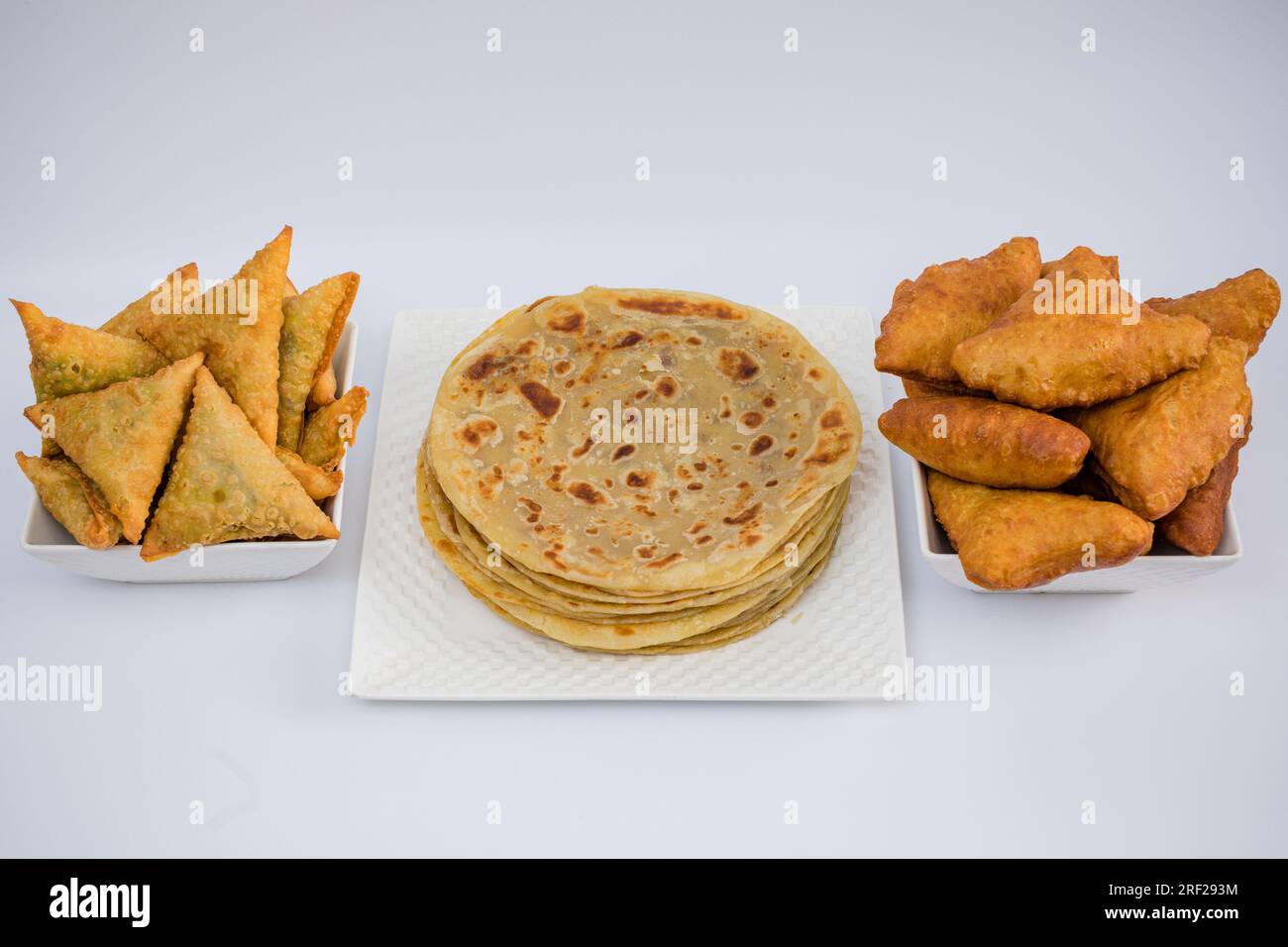Chapati Mandazi Andazi Samosa triangular-shaped snacks on a plate on a ...