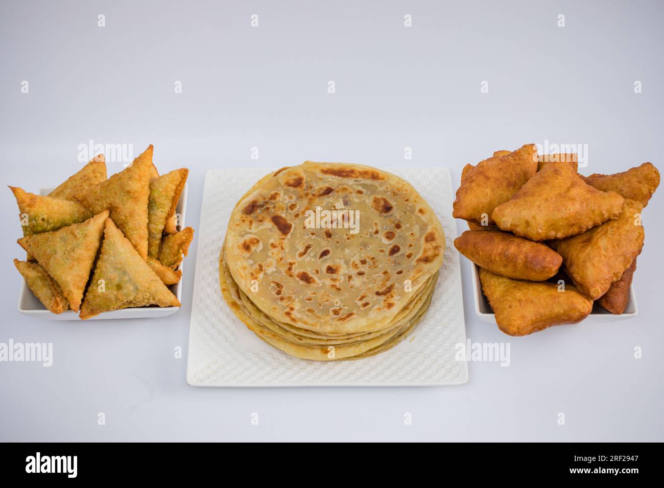 Chapati Mandazi Andazi Samosa triangular-shaped snacks on a plate on a ...