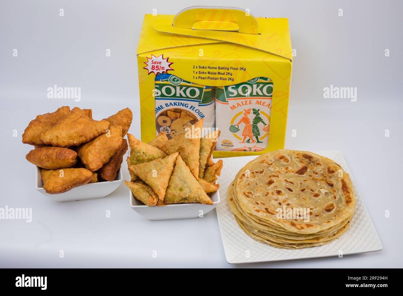 Chapati Mandazi Andazi Samosa triangular-shaped snacks on a plate on a ...