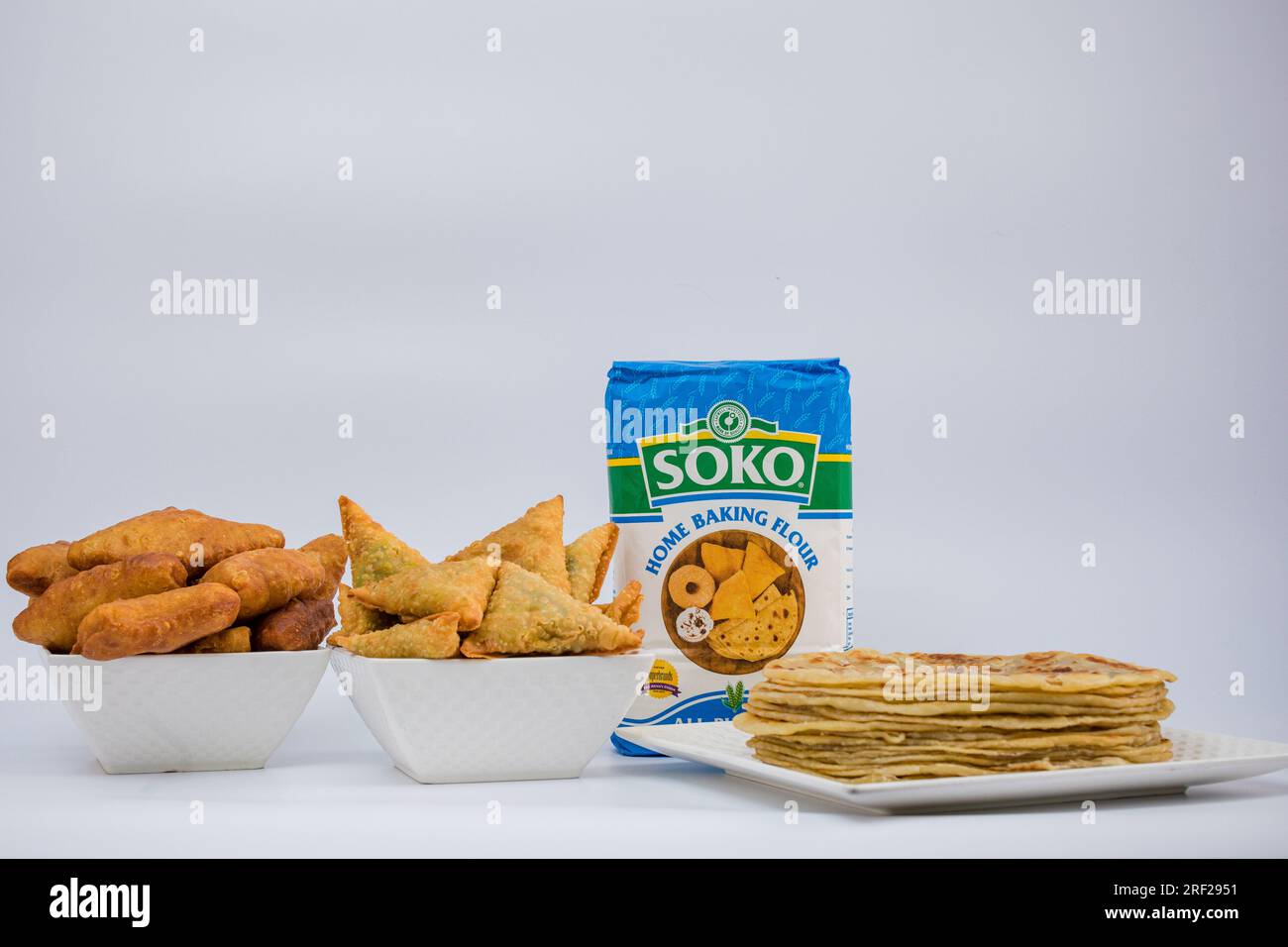 Chapati Mandazi Andazi Samosa triangular-shaped snacks on a plate on a ...