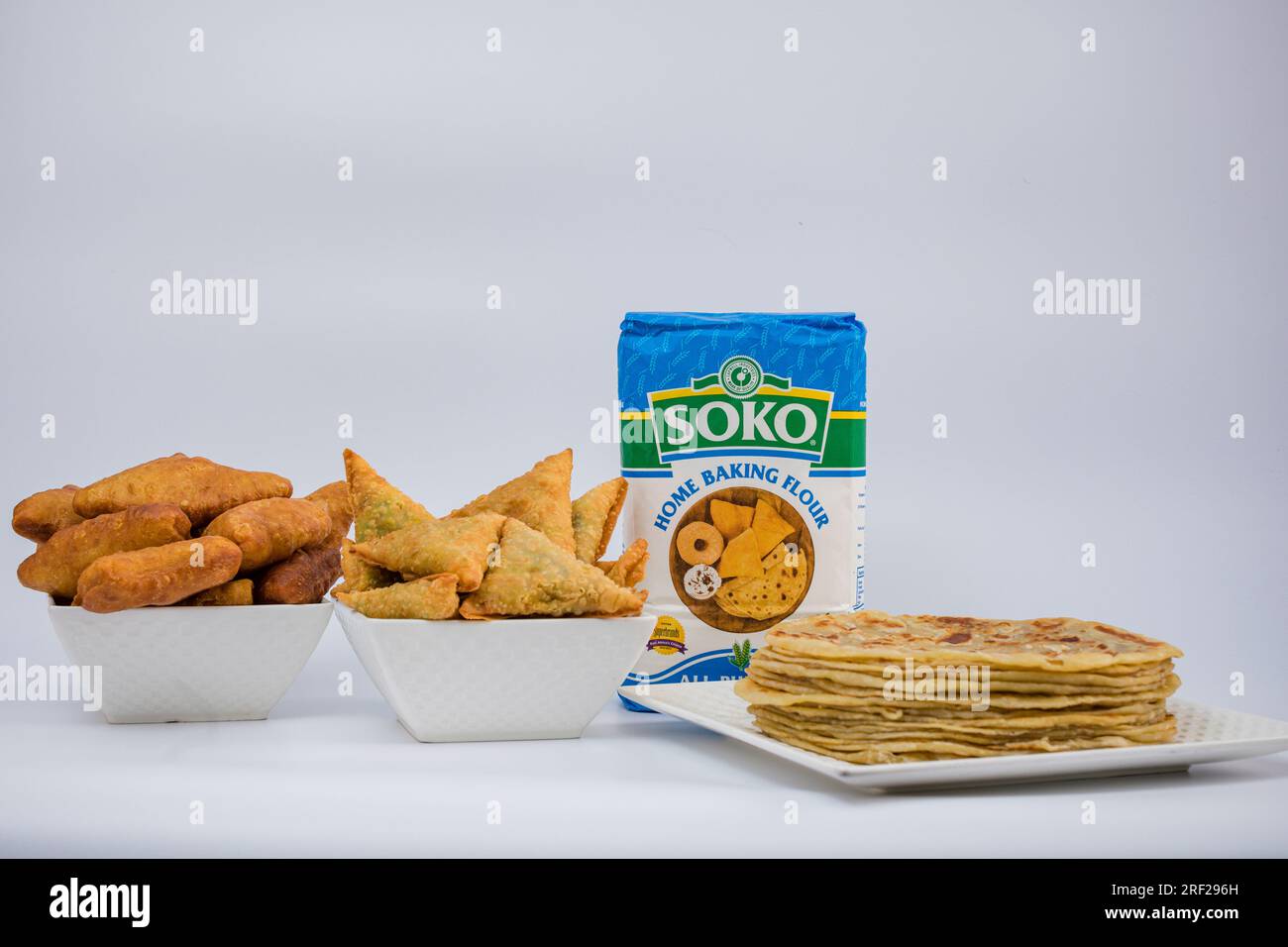 Chapati Mandazi Andazi Samosa triangular-shaped snacks on a plate on a ...
