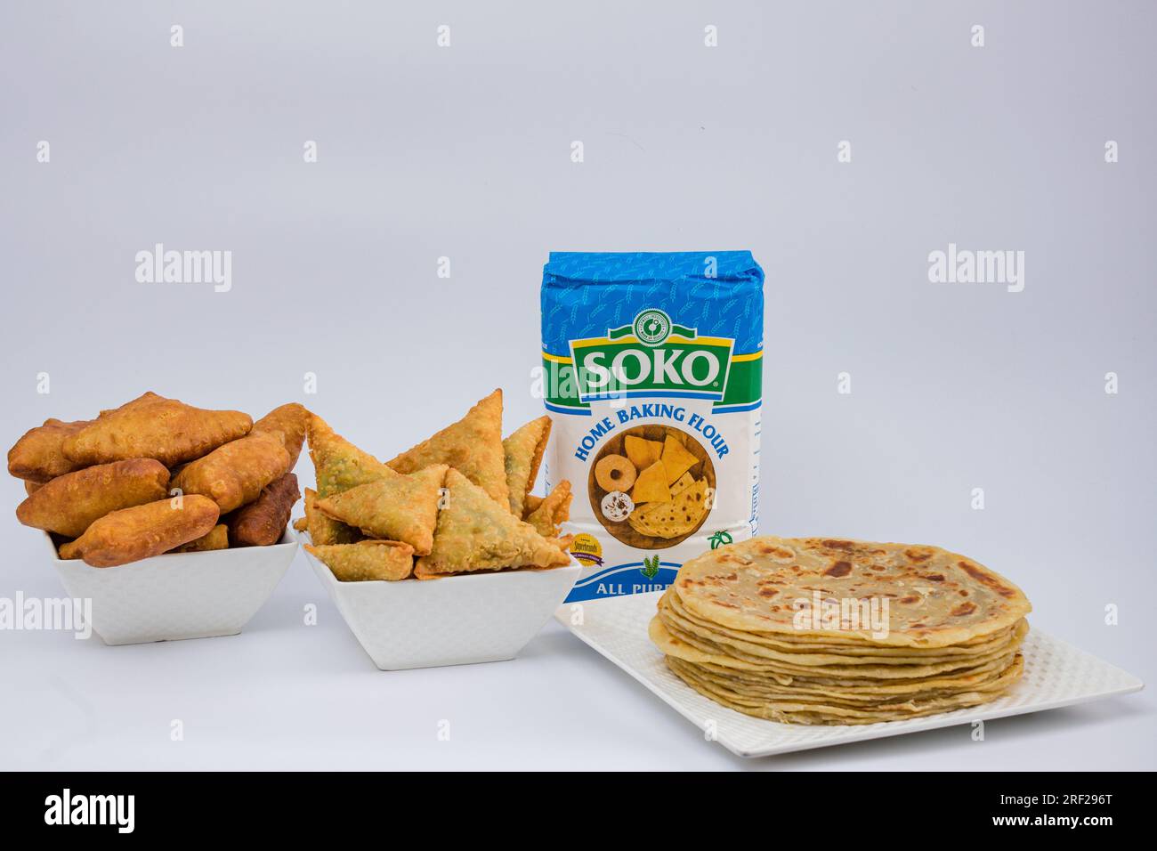Chapati Mandazi Andazi Samosa triangular-shaped snacks on a plate on a ...