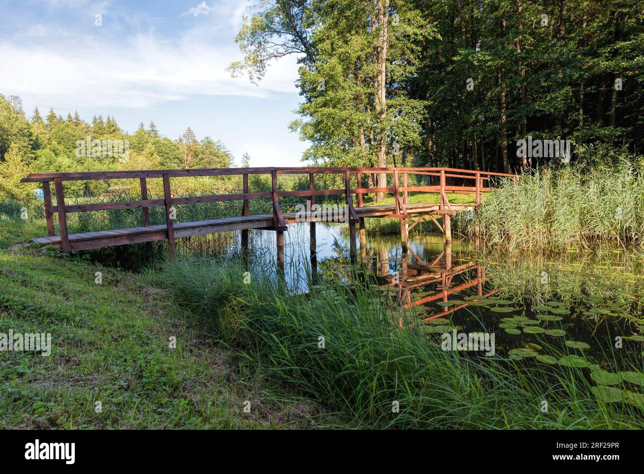 a simple wooden bridge built across a narrow river for the convenience ...