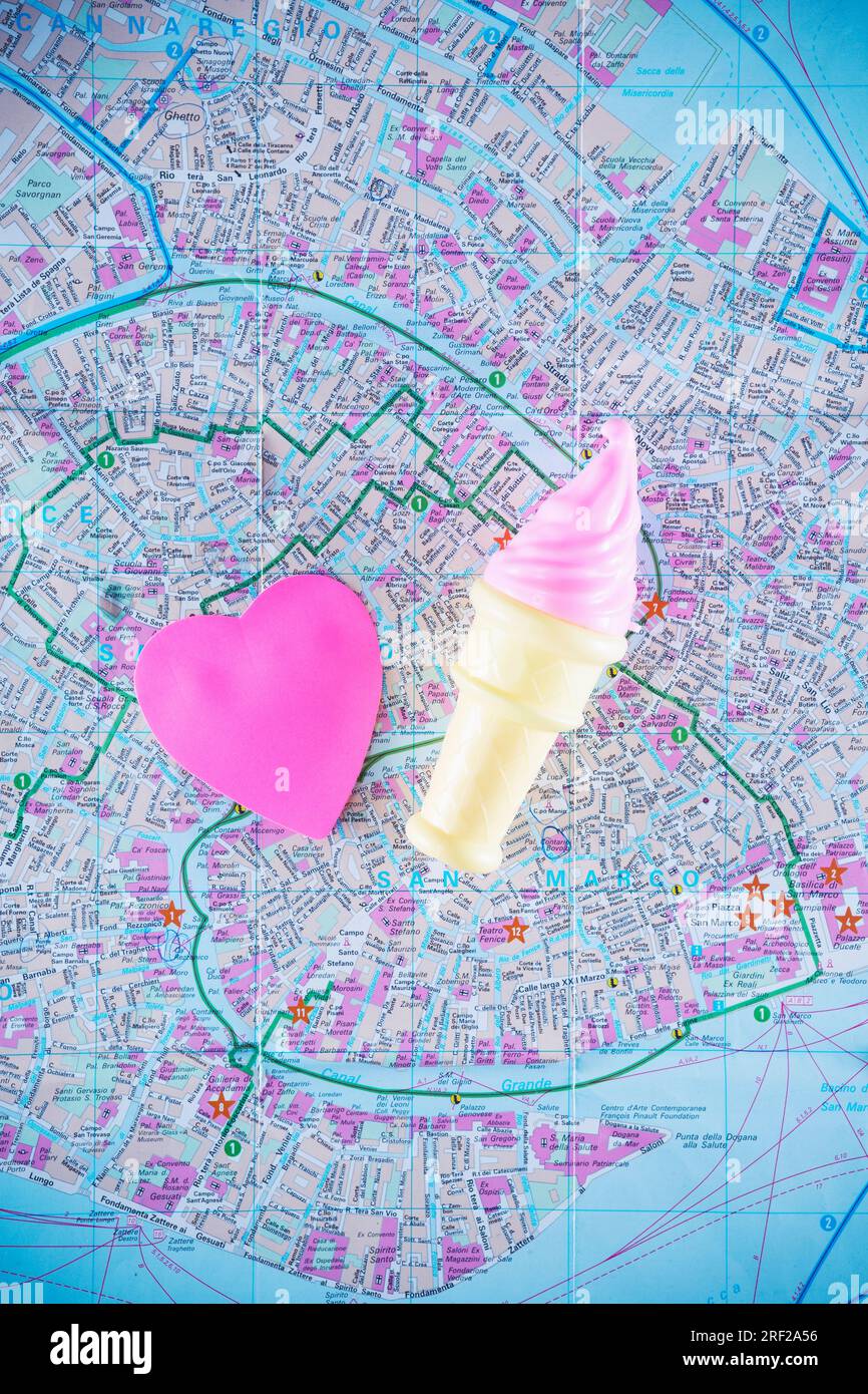 Top view on ice cream and heart-shaped sticker against map of Venice ...