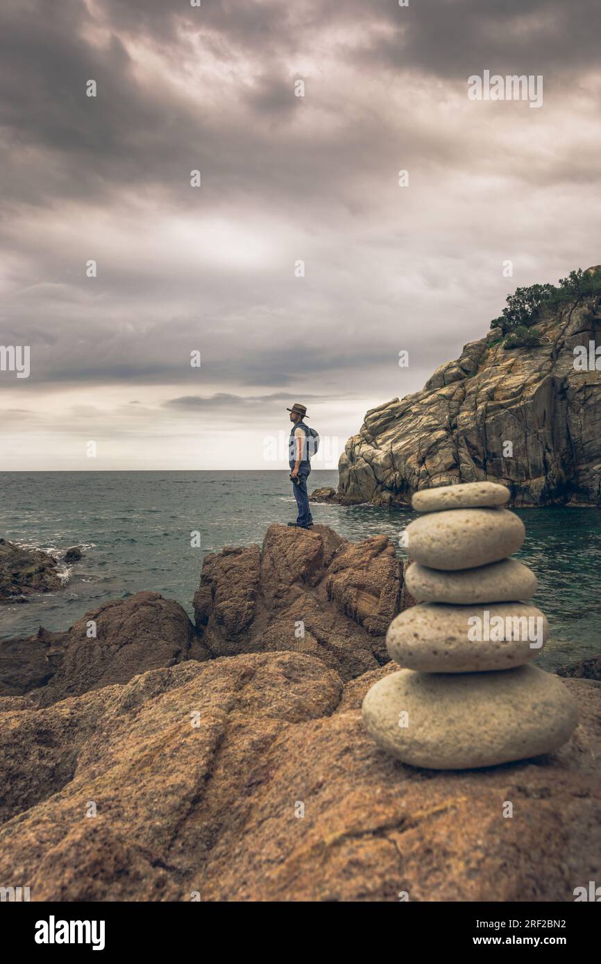 Adventurous man with photo camera and binoculars exploring a roc Stock ...