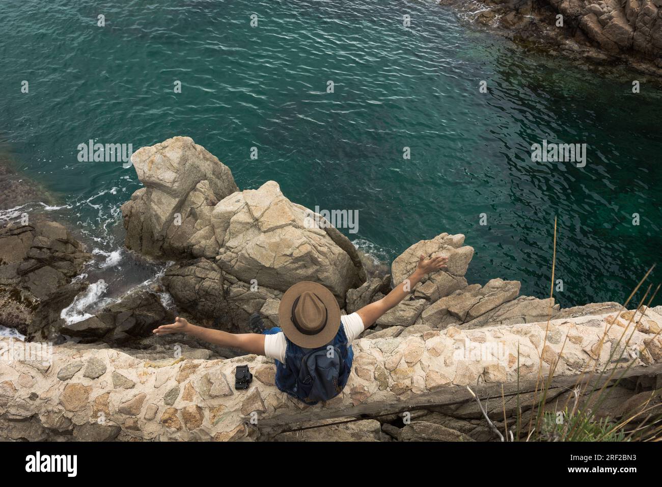 Adventurous man with photo camera and binoculars exploring a roc Stock ...