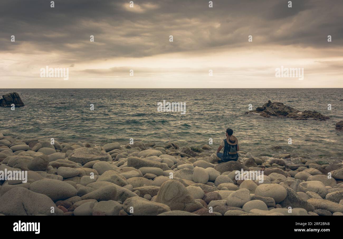 Adventurous man with photo camera and binoculars exploring a roc Stock ...