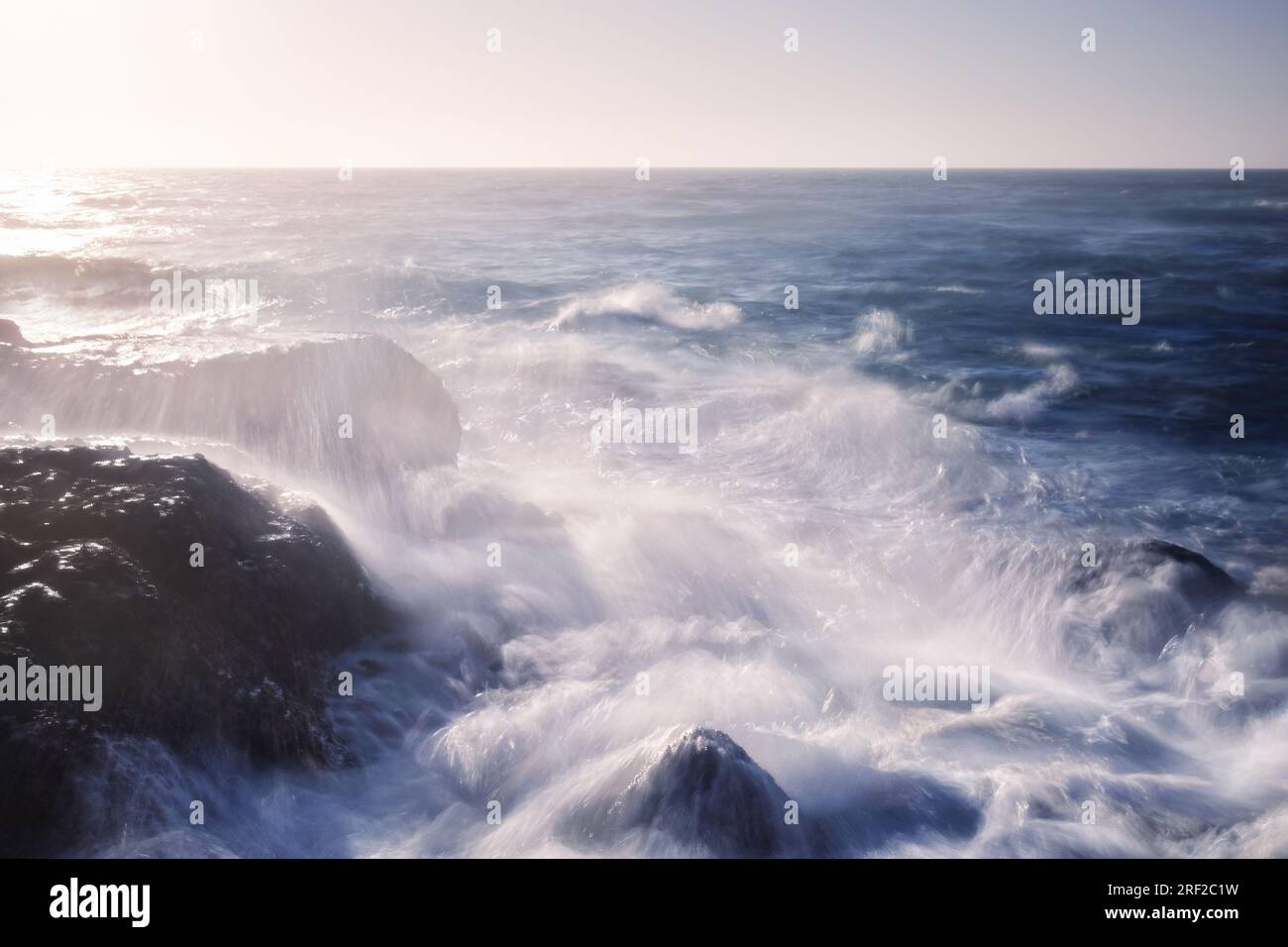 Sea at sunrise with motion waves due to a long exposure Stock Photo - Alamy