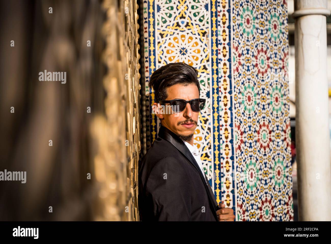 Moroccan man with sunglasses and suit next to Royal Palace in Fe Stock ...