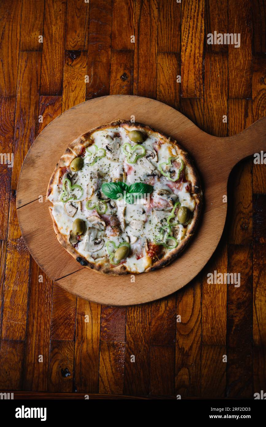 Creative capricciosa pizza on the rustic table ready for sale Stock ...