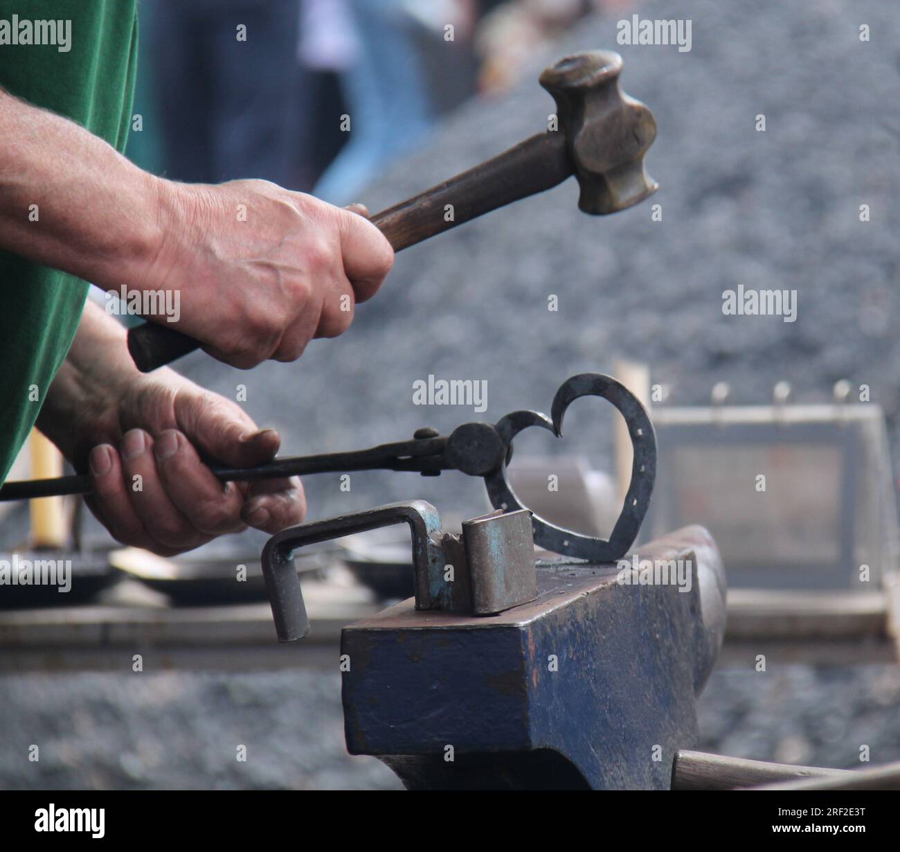 A Blacksmith Making a Metal Heart with a Hammer and Anvil Stock Photo ...