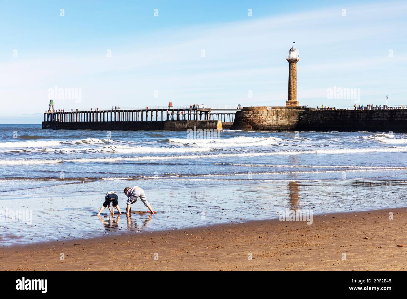 Kids playing on Whitby beach, kids playing in sand, Whitby, Yorkshire ...