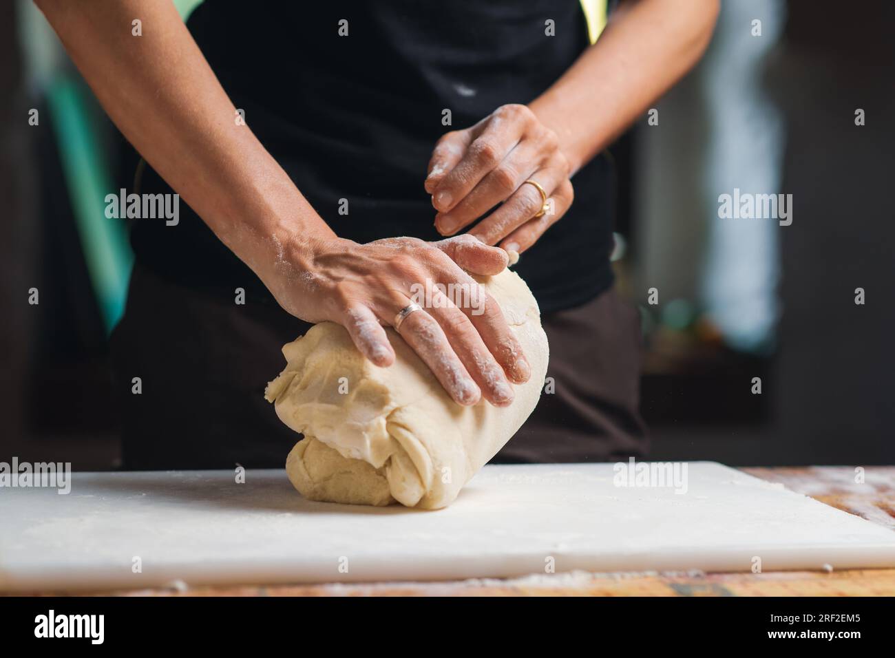 Cooking dough. Women's hands kneading dough in kitchen. Unrecognizable ...