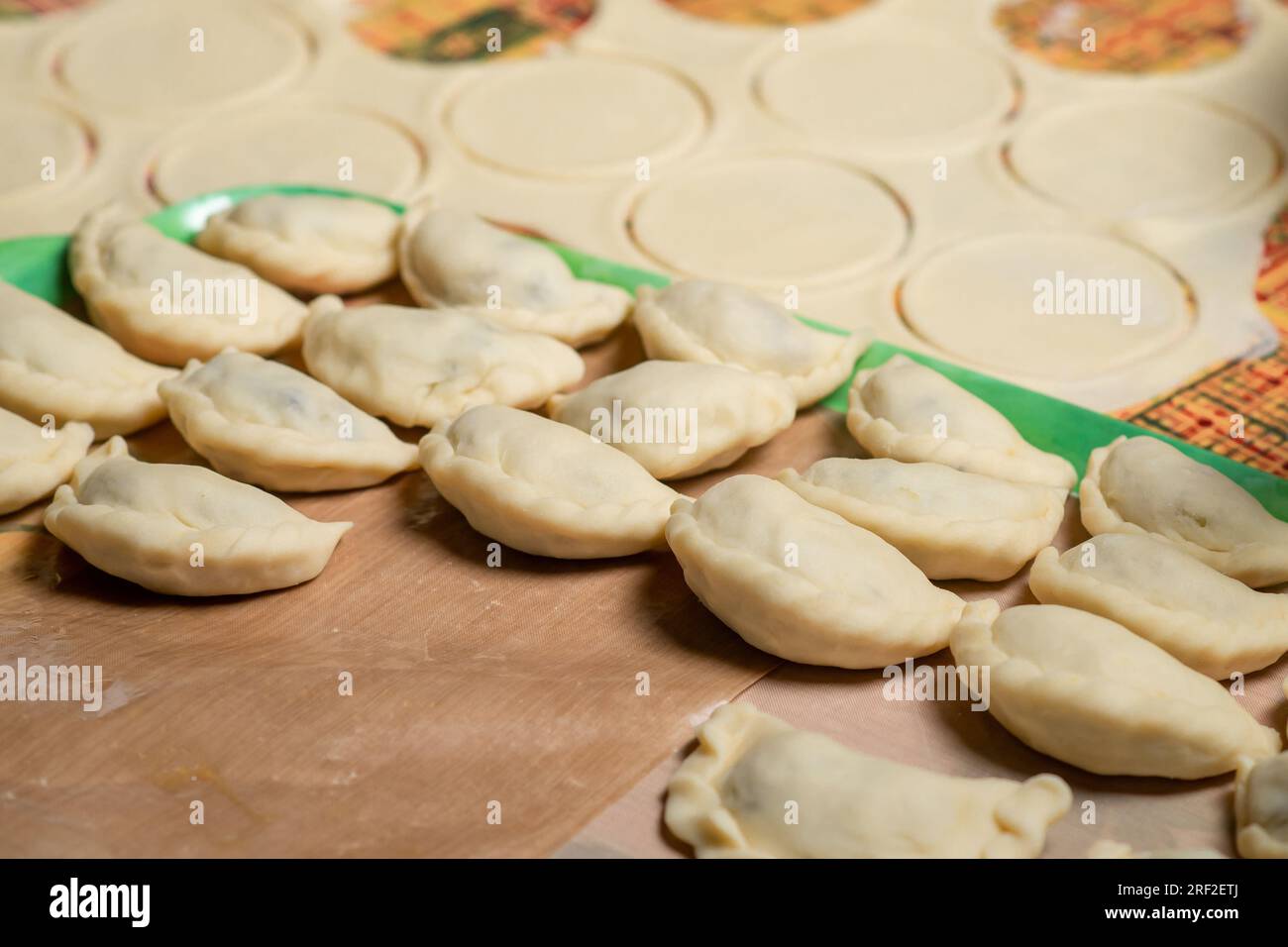 Homemade dumplings cobbled together by hand on paper. Sculpting ...