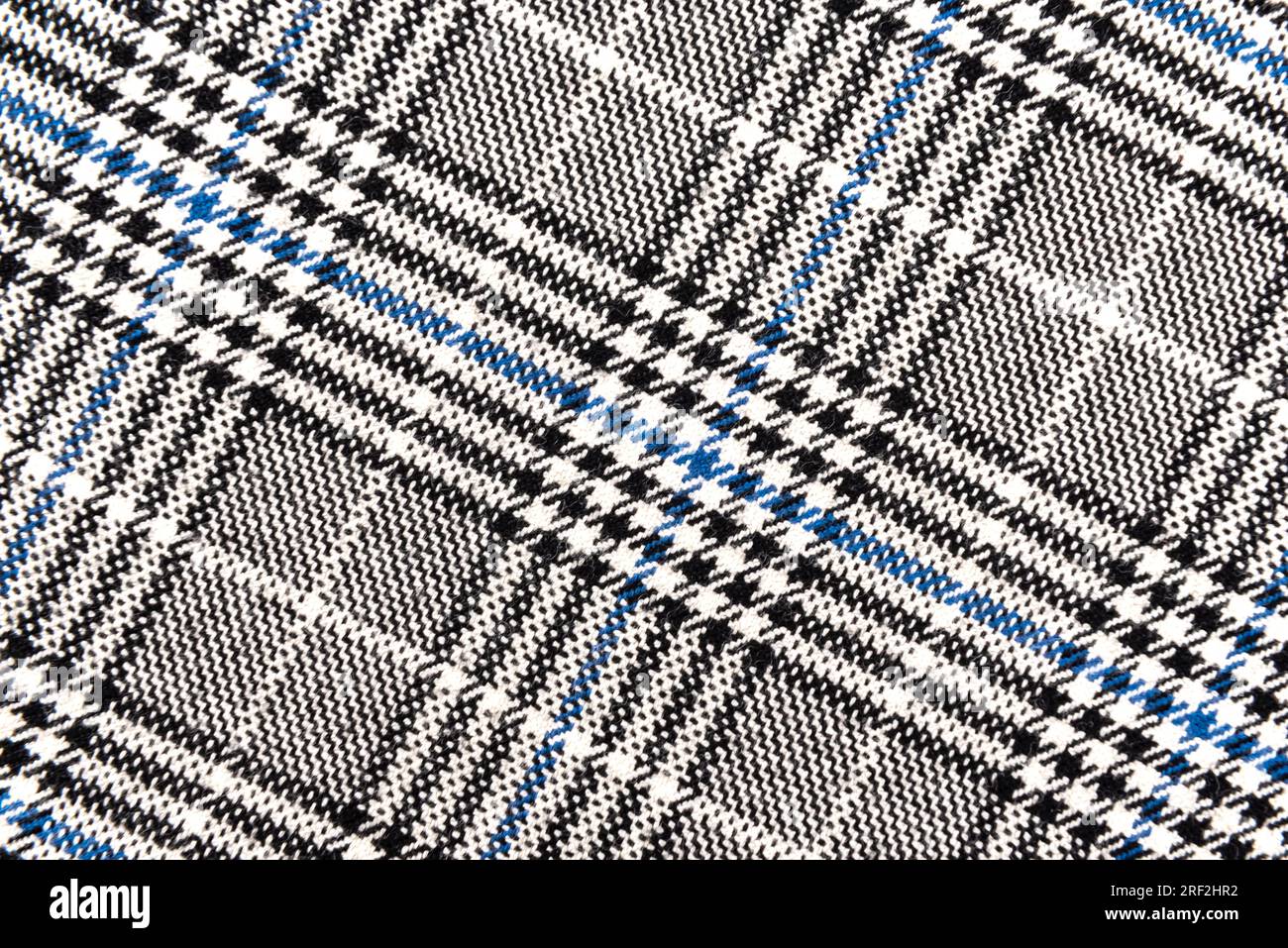 The texture of linen fabric in a large cell of black, blue and white ...