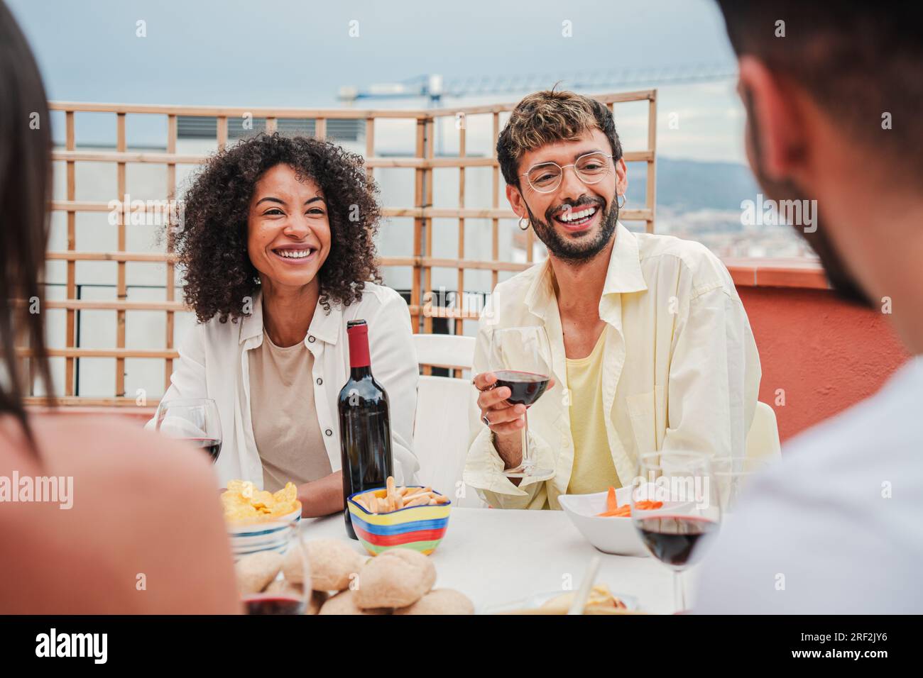 Gathering of people enjoying the good weather sitting at the table ...