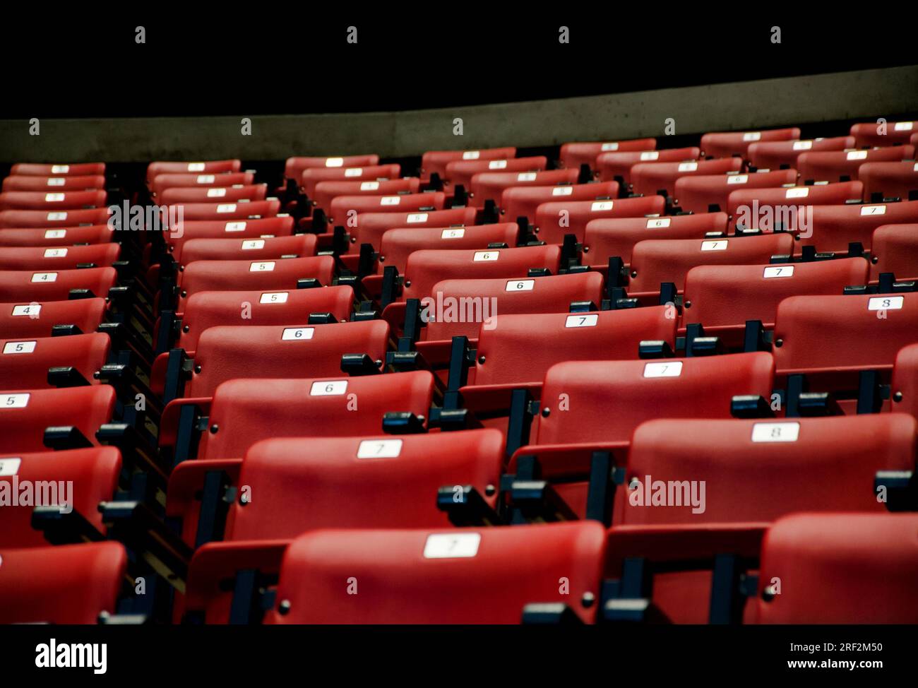 Modern conference room full of red plastic seats Stock Photo - Alamy