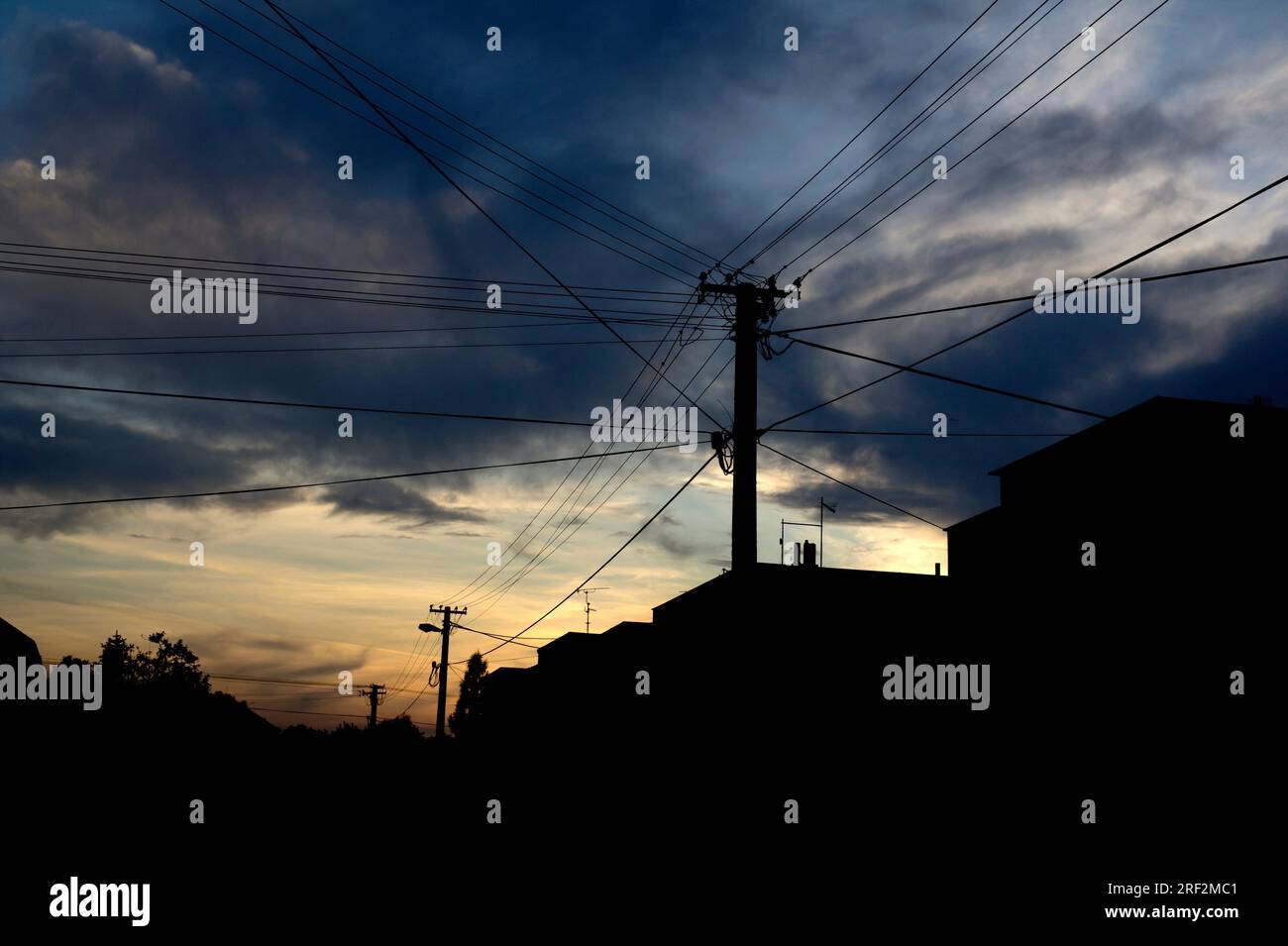 Electric cables and wires above the buildings at sunset Stock Photo - Alamy