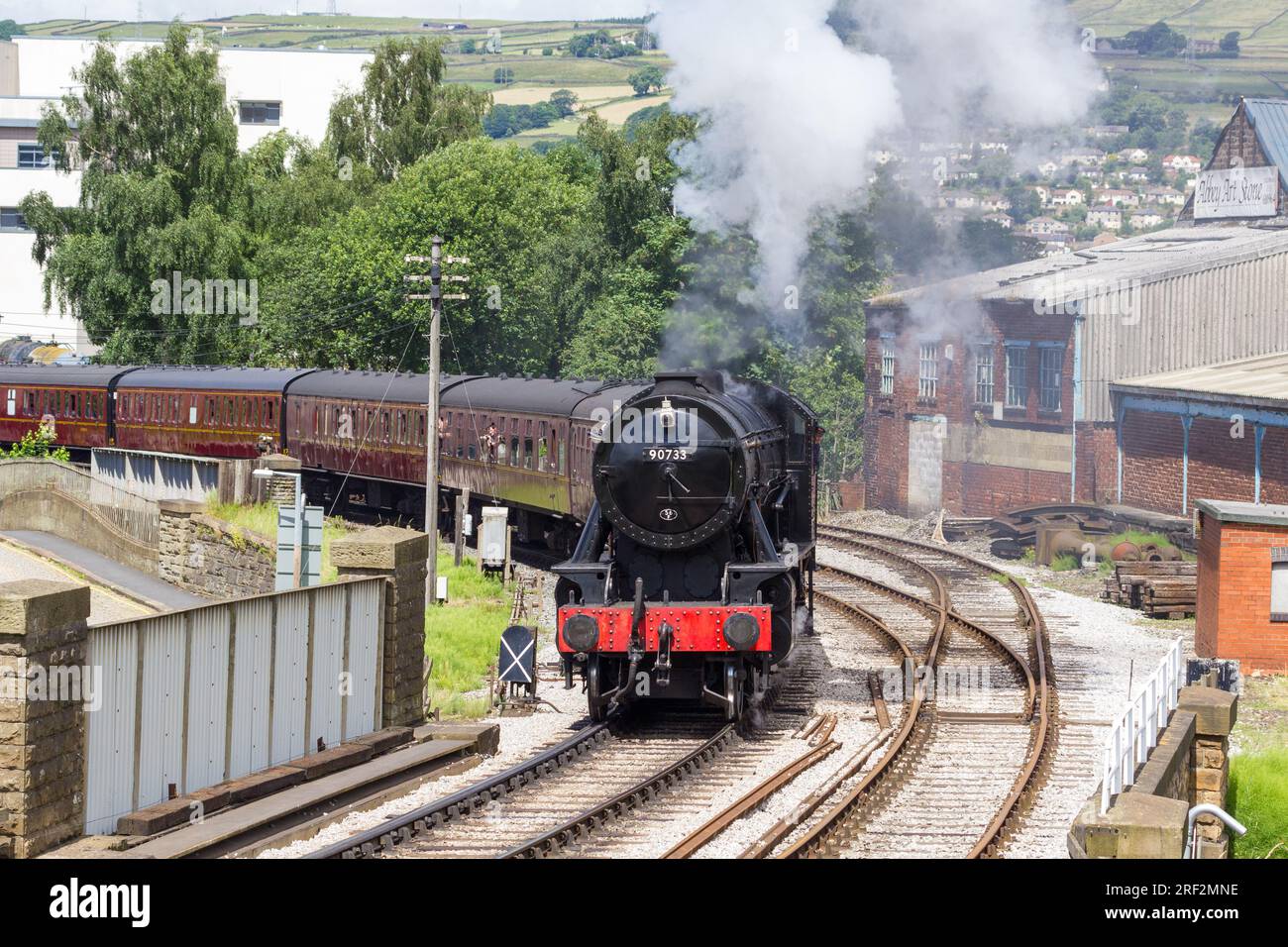 A passenger train departing from Keighley station on the KWVR railway ...