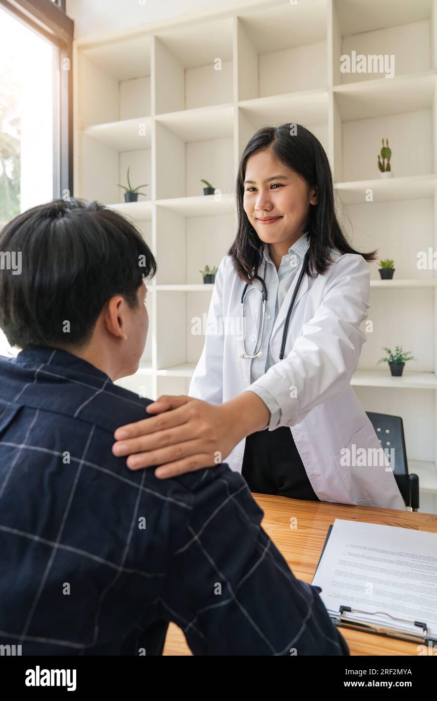 Asian female doctor giving hope and encourage to stressed man patient ...