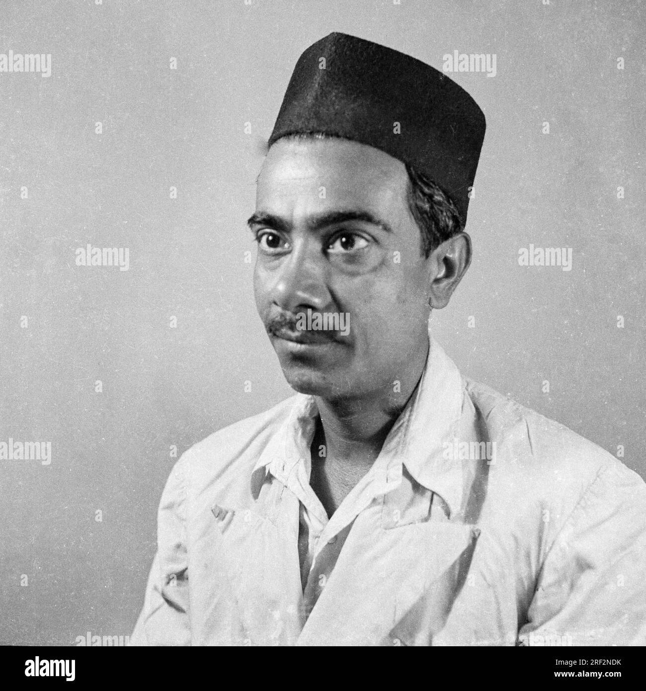 old vintage 1900s black and white studio portrait of Indian man wearing ...