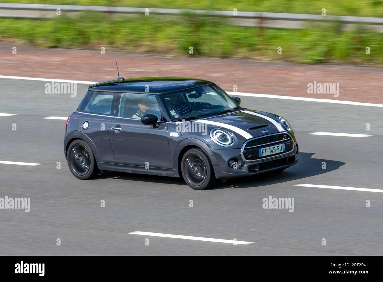 French Mini Cooper S; travelling at speed on the M6 motorway in Greater ...